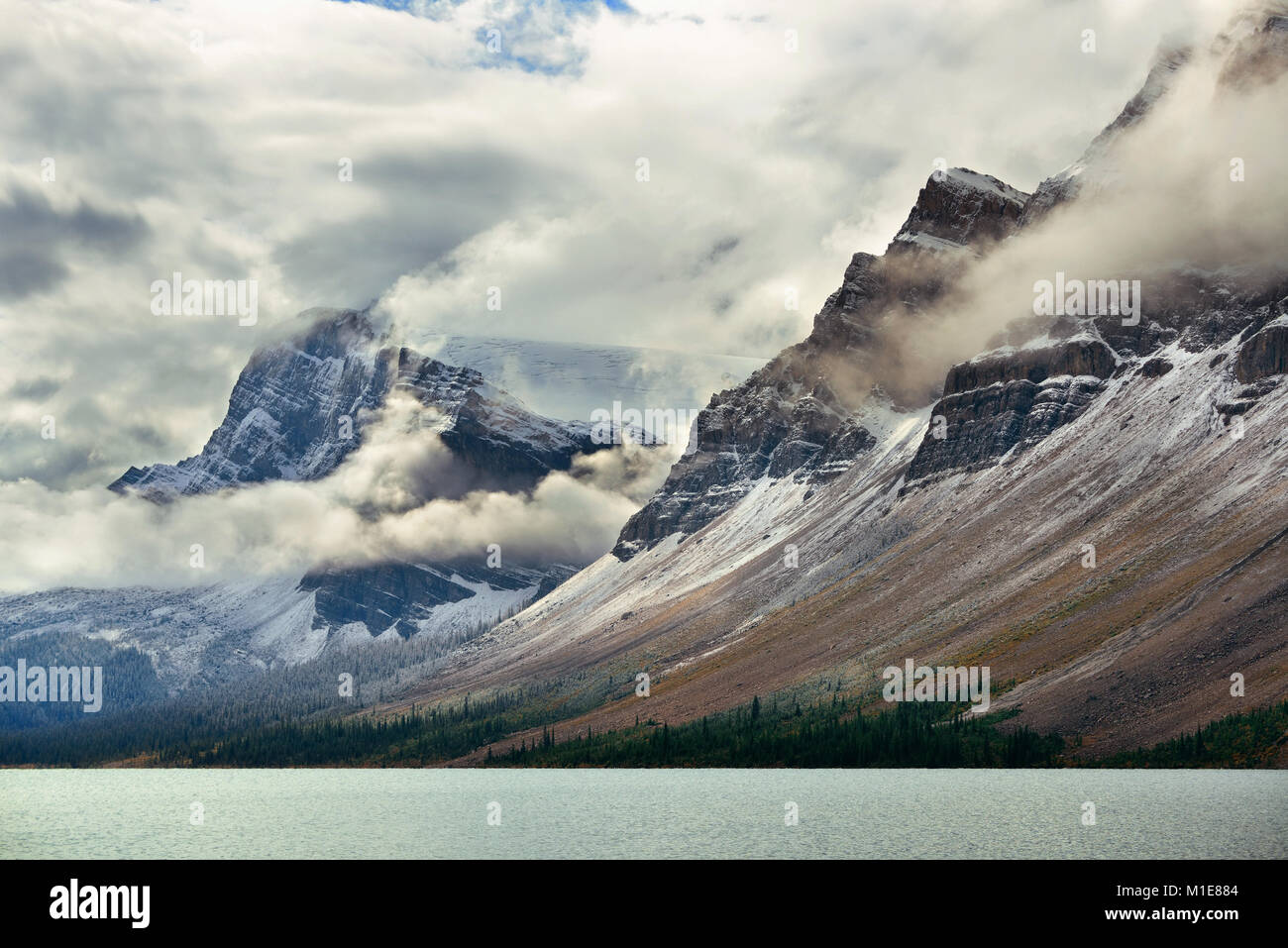 Snow Mountain with fog and lake forest Stock Photo - Alamy
