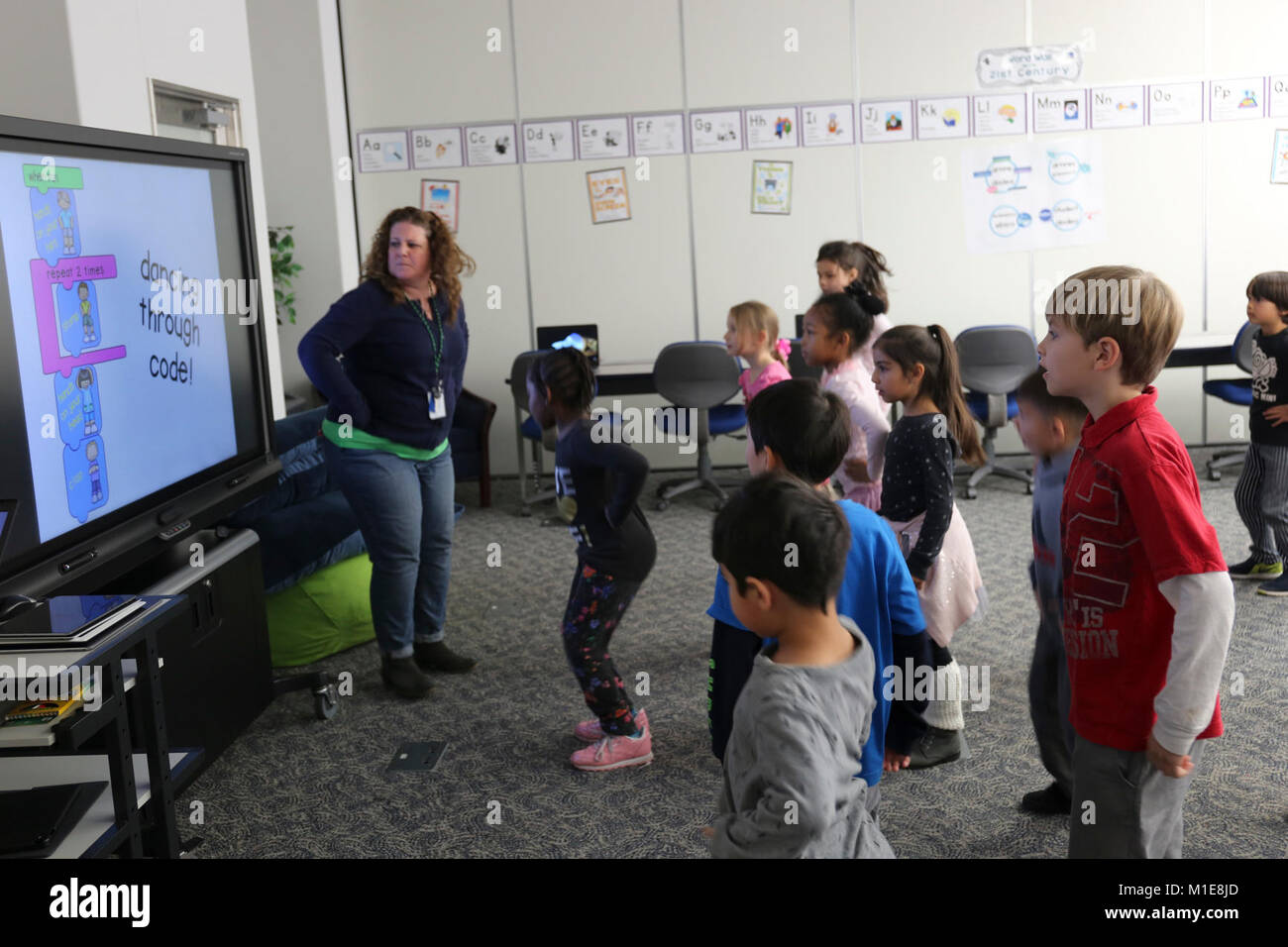 Youth members participate in a dancing exercise to learn about computer ...