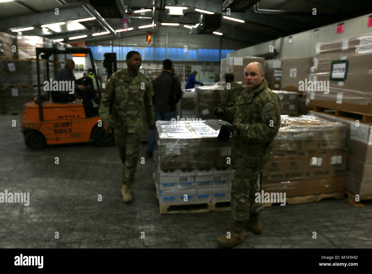 US Soldiers mark food pallets for transport to their respective units ...