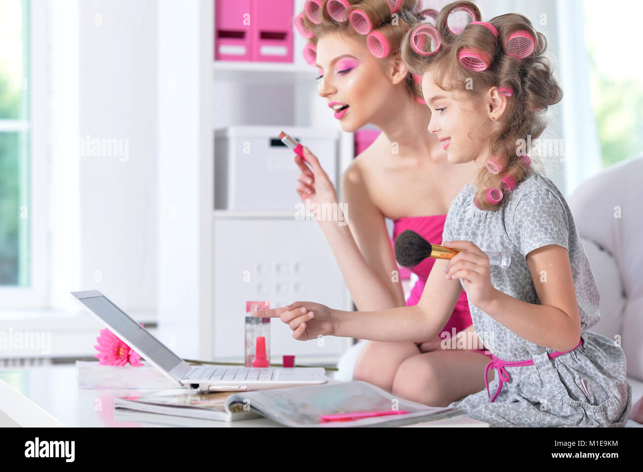 mother with cute daughter doing makeup Stock Photo - Alamy