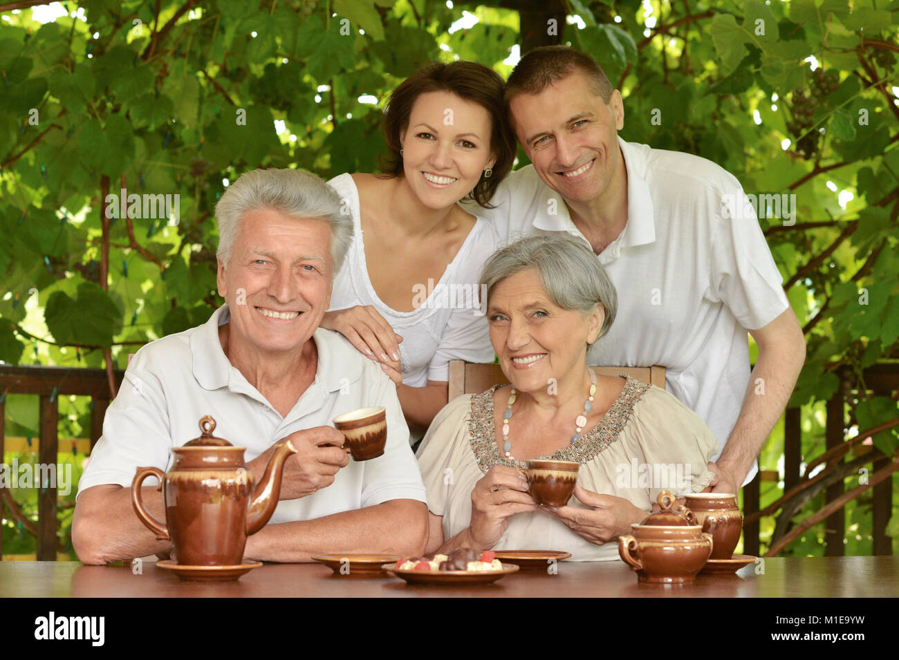 Family drinking tea outdoors Stock Photo - Alamy
