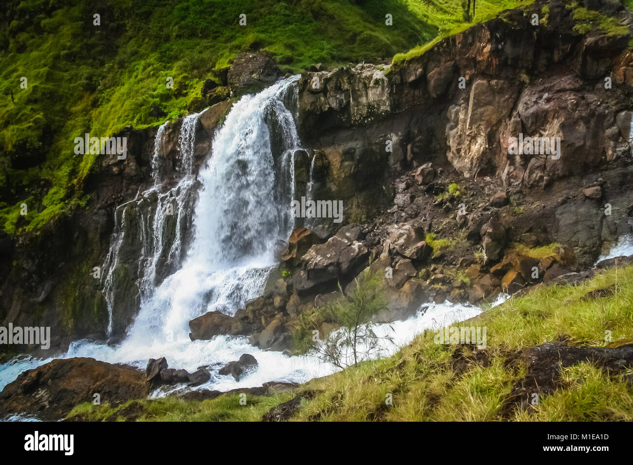 Waterfall with a water coming out of crater lake of Gunung Rinjani ...