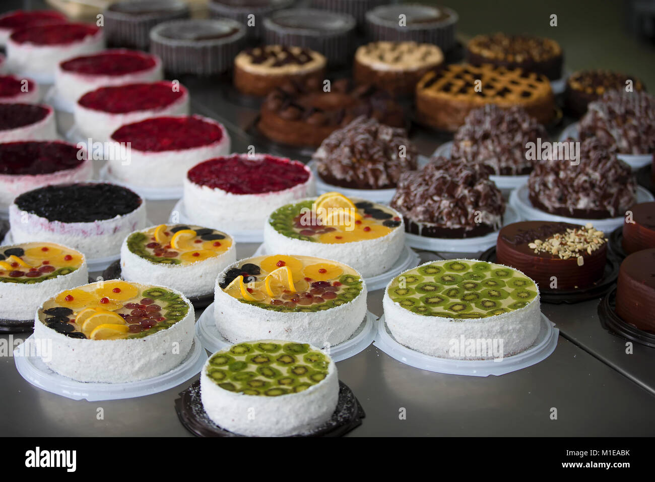 Cake and baking line.Industrial line of cakes. Many beautiful cakes on ...