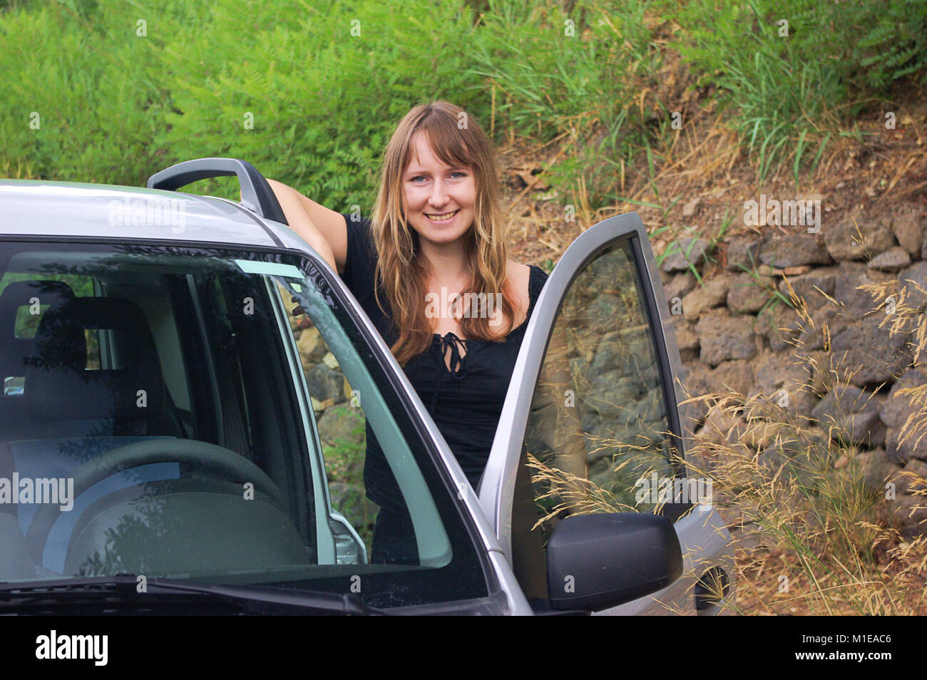 Young beautiful girl in the car on the nature Stock Photo - Alamy