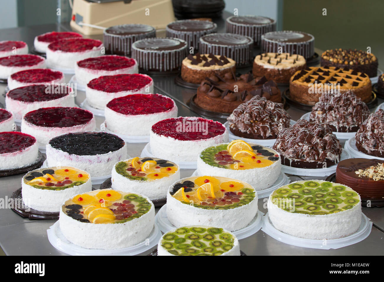 Cake and baking line.Industrial line of cakes. Many beautiful cakes on ...