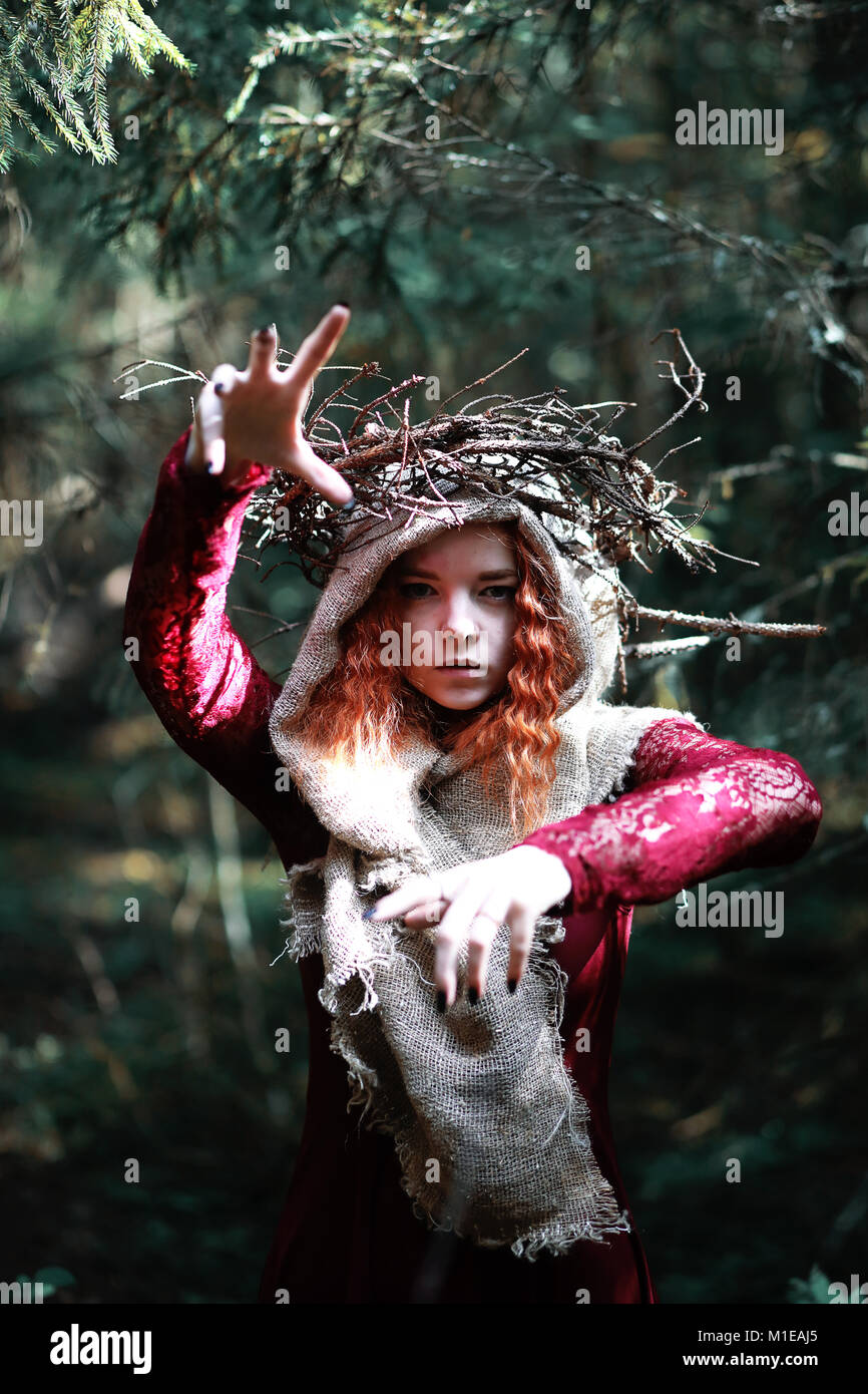 The red-haired witch holds a ritual with a crystal ball Stock Photo - Alamy