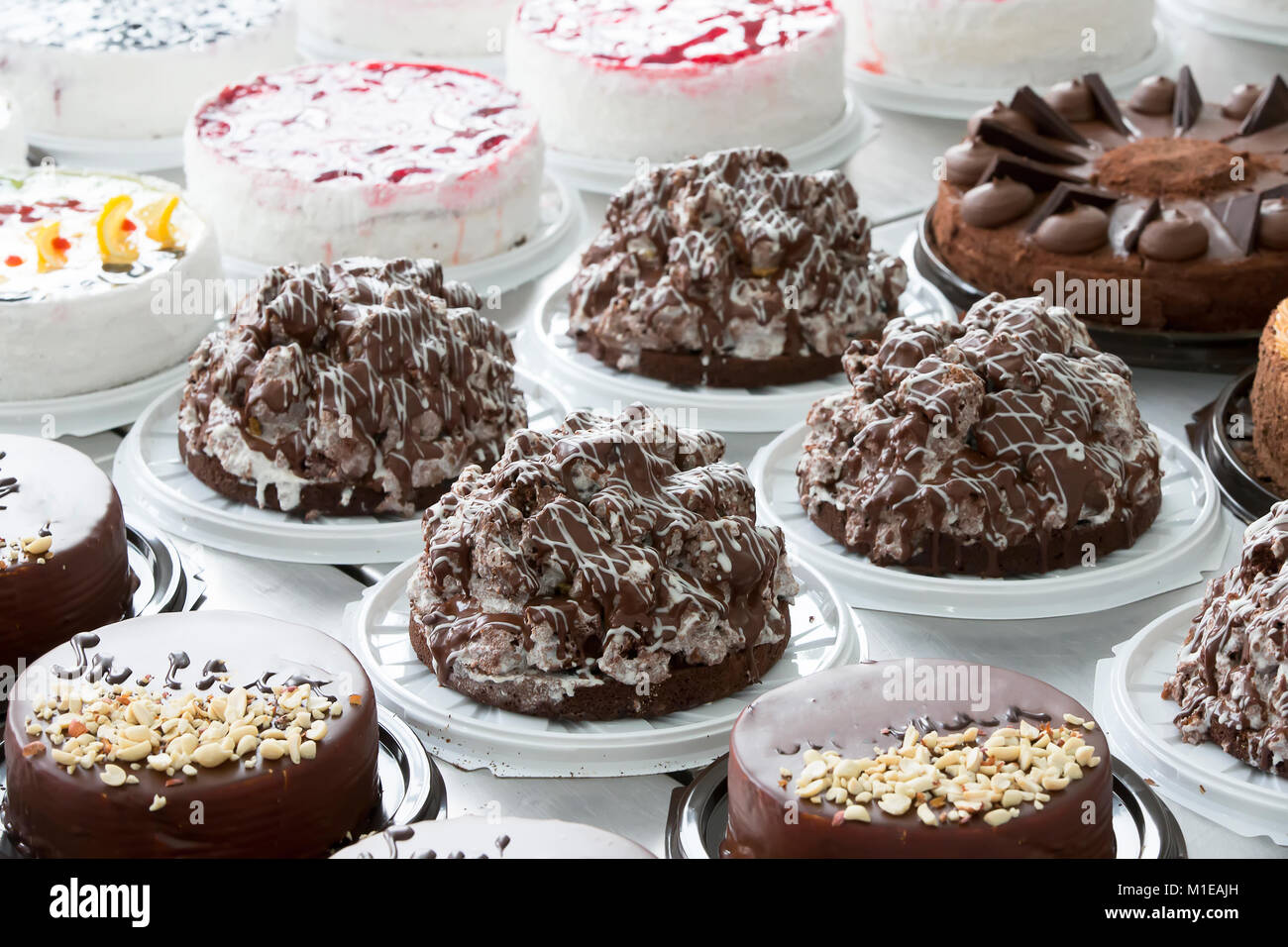 Cake and baking line.Industrial line of cakes. Many beautiful cakes on ...