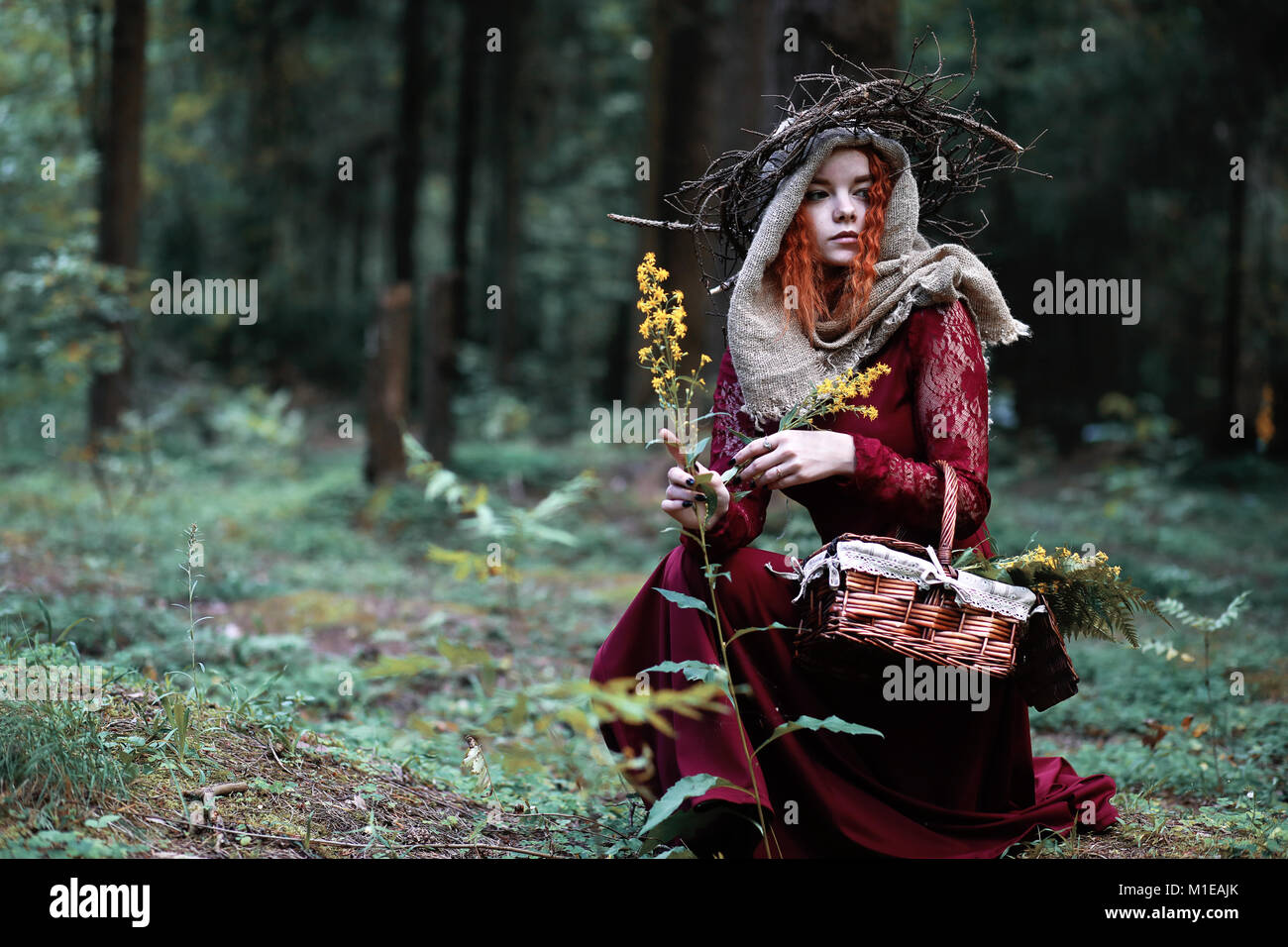 The red-haired witch holds a ritual with a crystal ball Stock Photo - Alamy