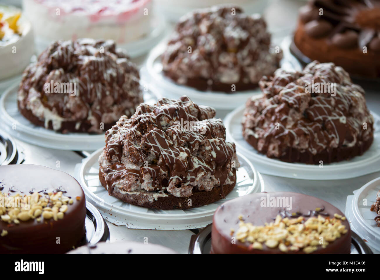 Cake and baking line.Industrial line of cakes. Many beautiful cakes on ...