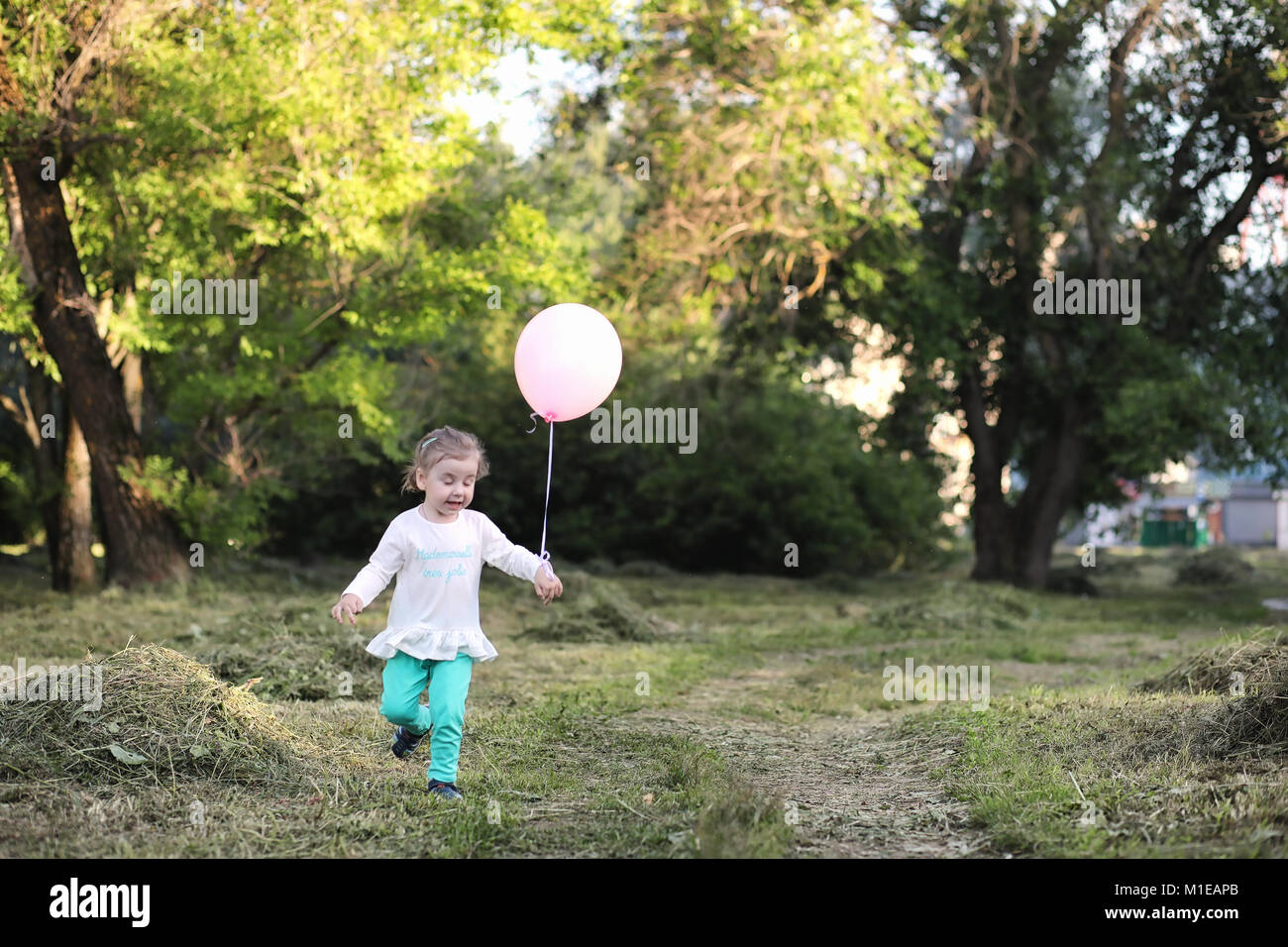 Little children are walking in a park Stock Photo - Alamy