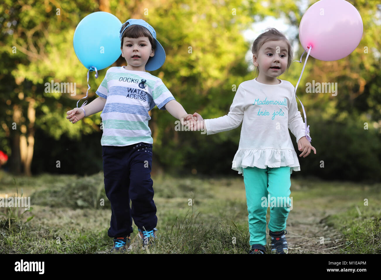 Little children are walking in a park Stock Photo - Alamy
