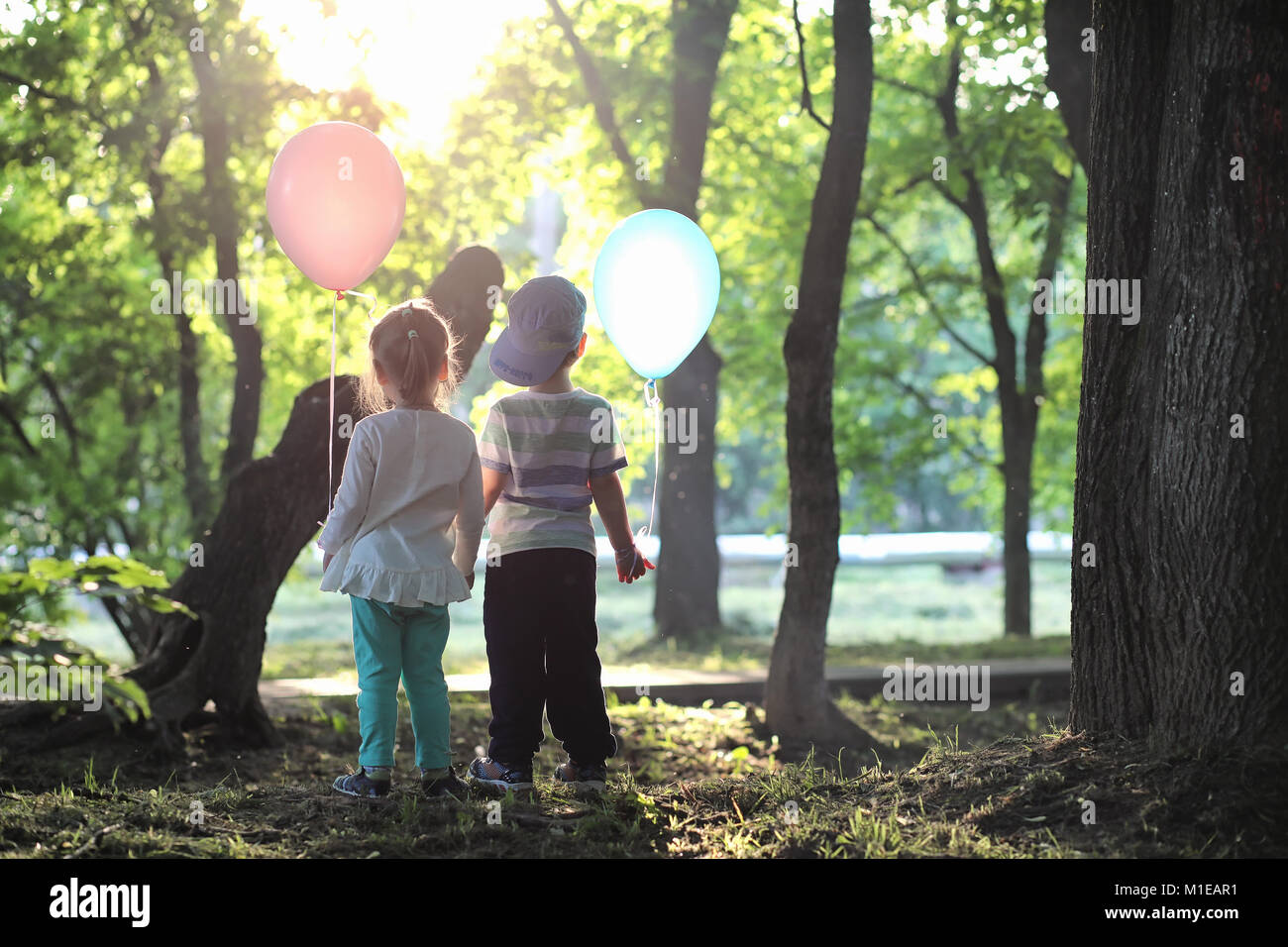 Little children are walking in a park Stock Photo - Alamy