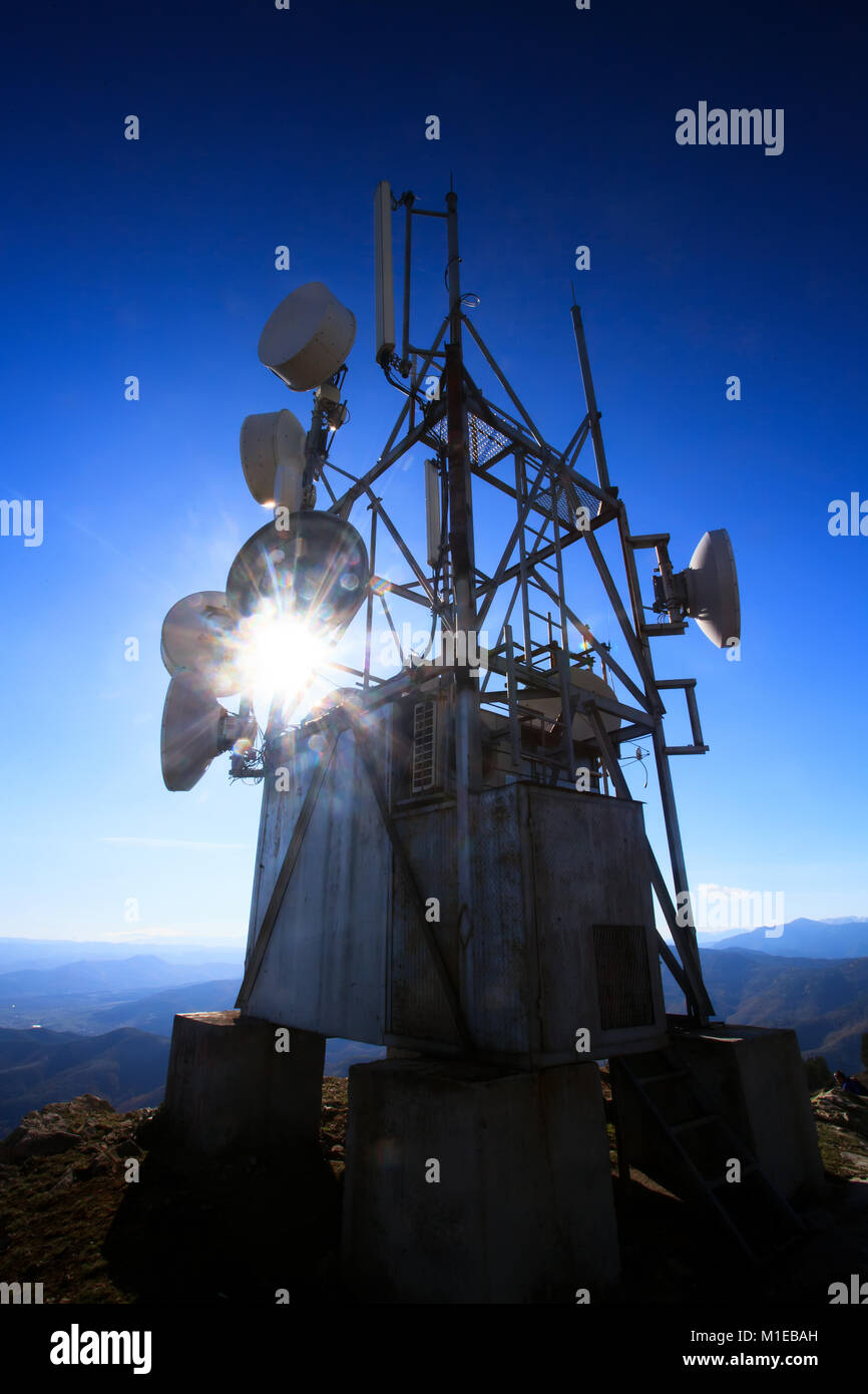 sun starr over the telecomunications antenna Stock Photo - Alamy