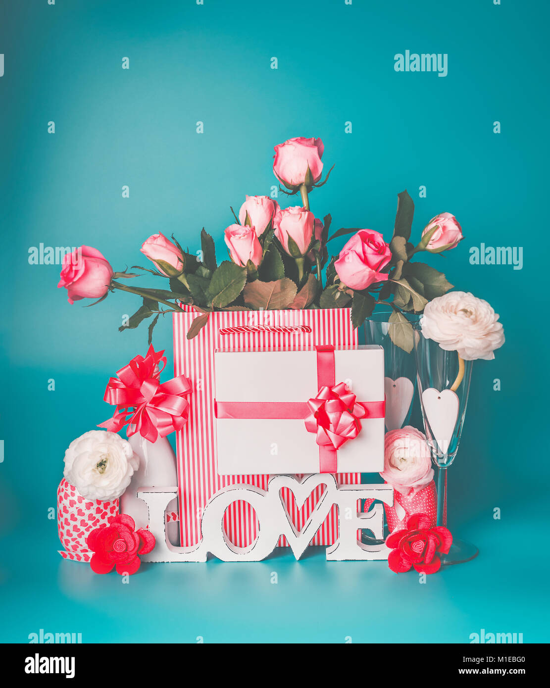 Romantic greeting setting with word LOVE, gift box, heart, bunch of ...