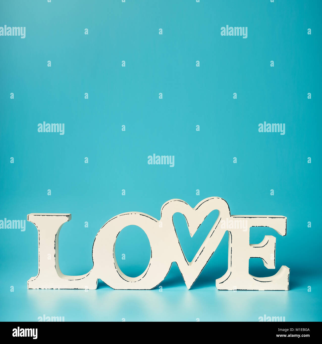 White word LOVE on turquoise blue background, front view. Modern layout ...