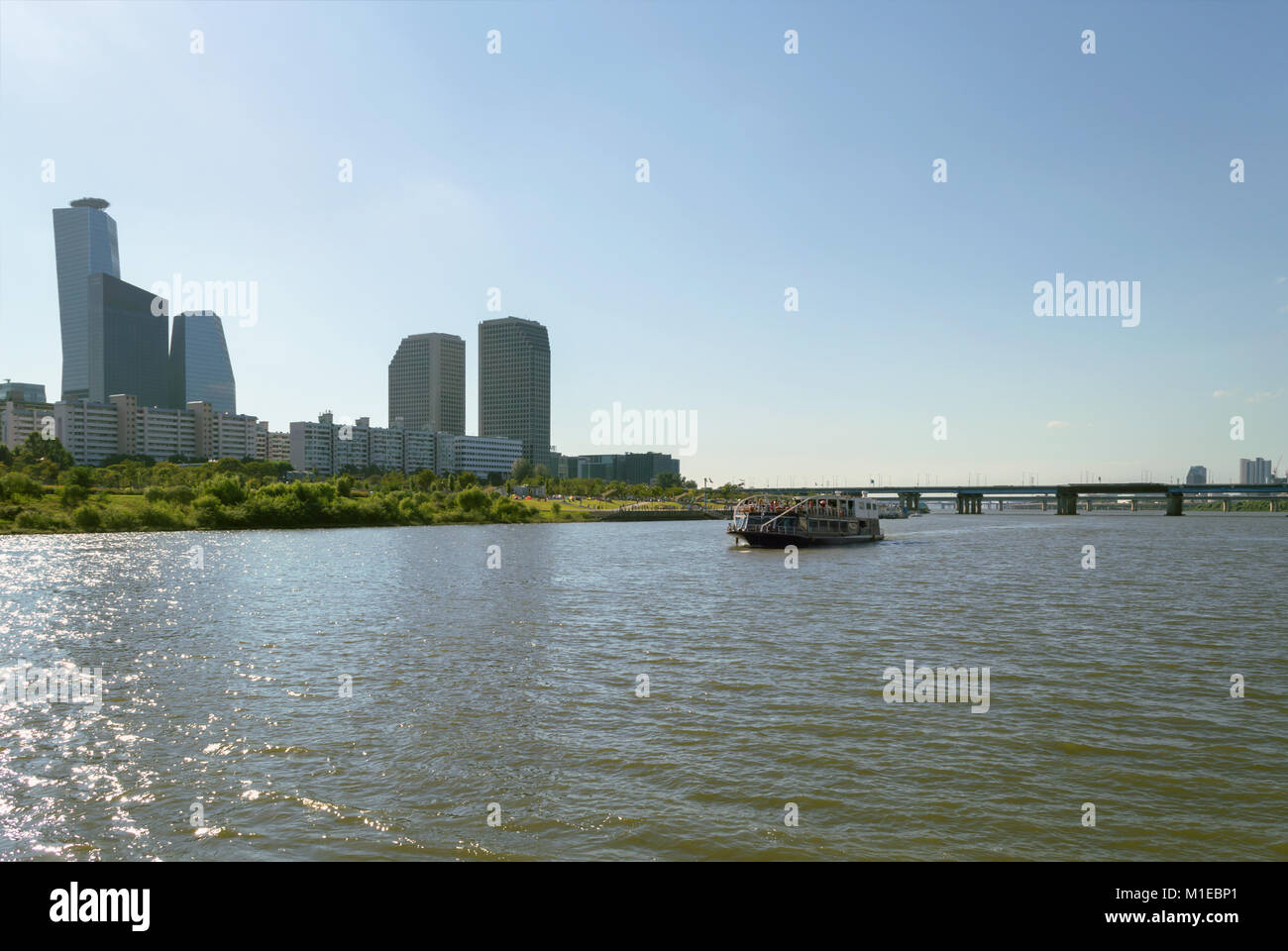 Han river with cruise ship and part of Seoul skyscrappers Stock Photo ...