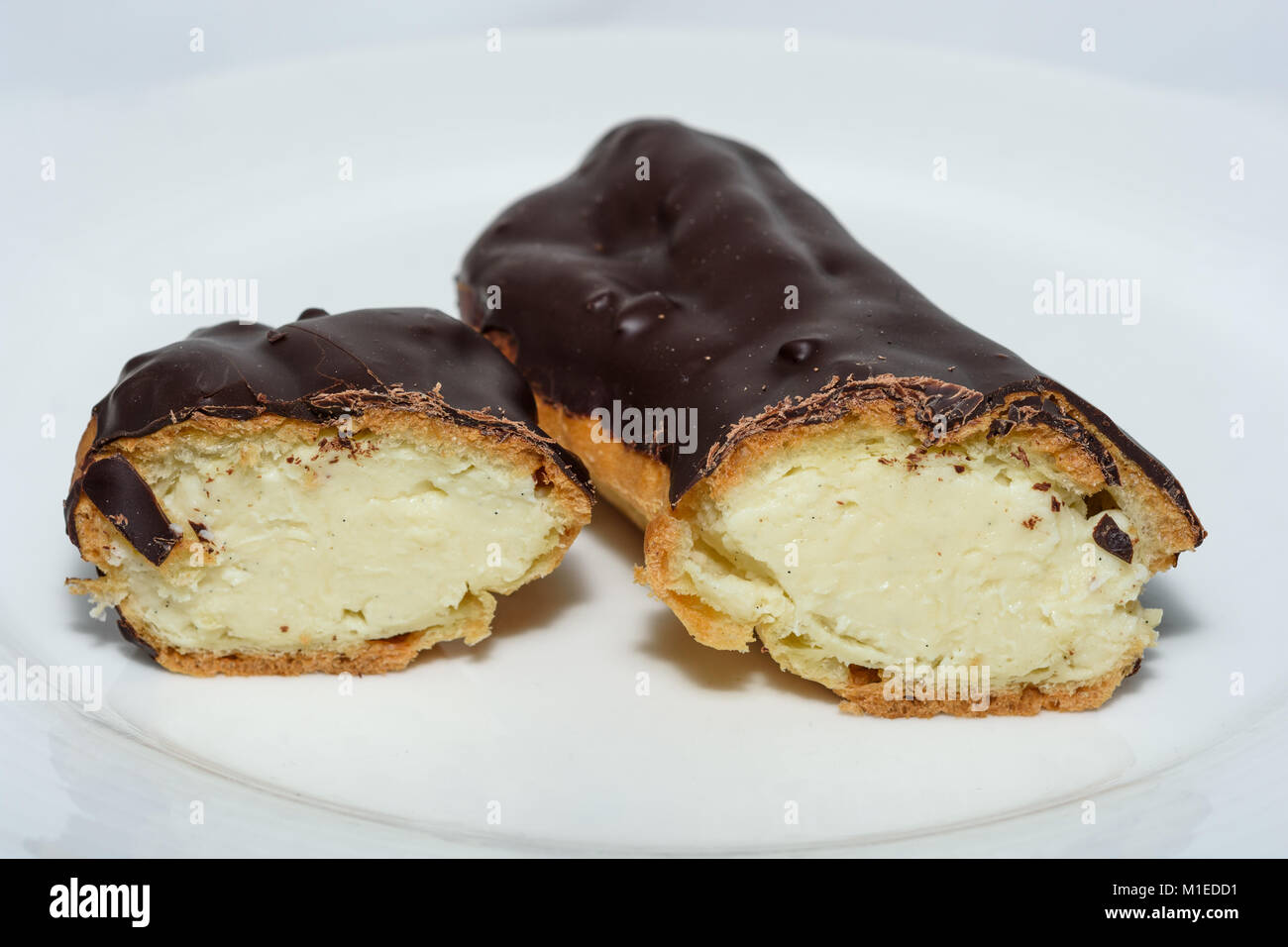 cut eclair on white background Stock Photo - Alamy