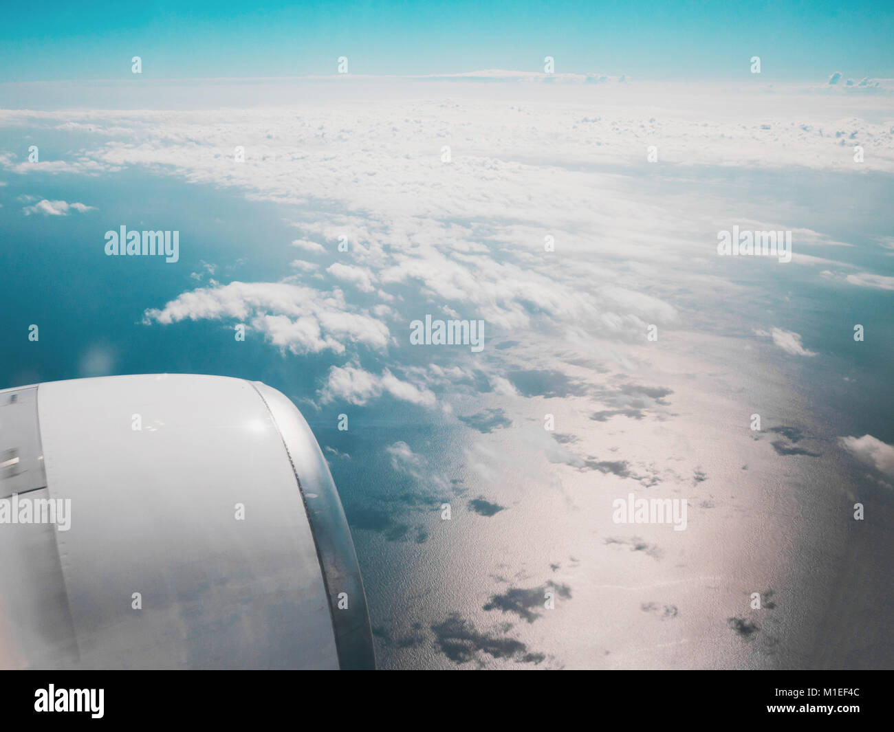 Aerial view of blue ocean and clouds from airplane window Stock Photo ...