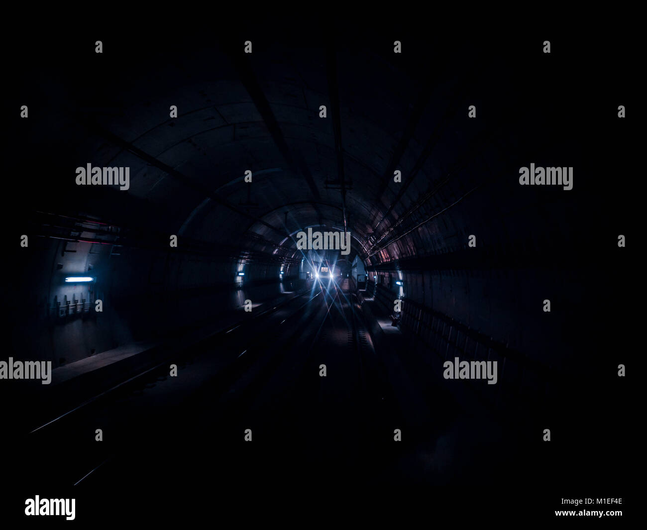 View of a subway tunnel from the front of a moving train. Fast ...