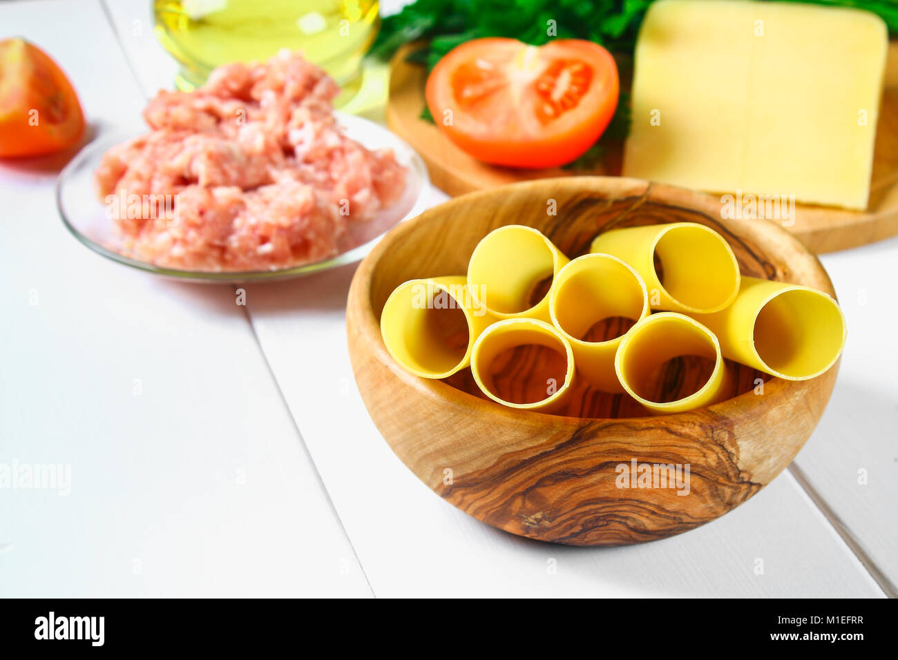 Italian pasta cannelloni. Raw tube for stuffing stuffing surrounded by ...