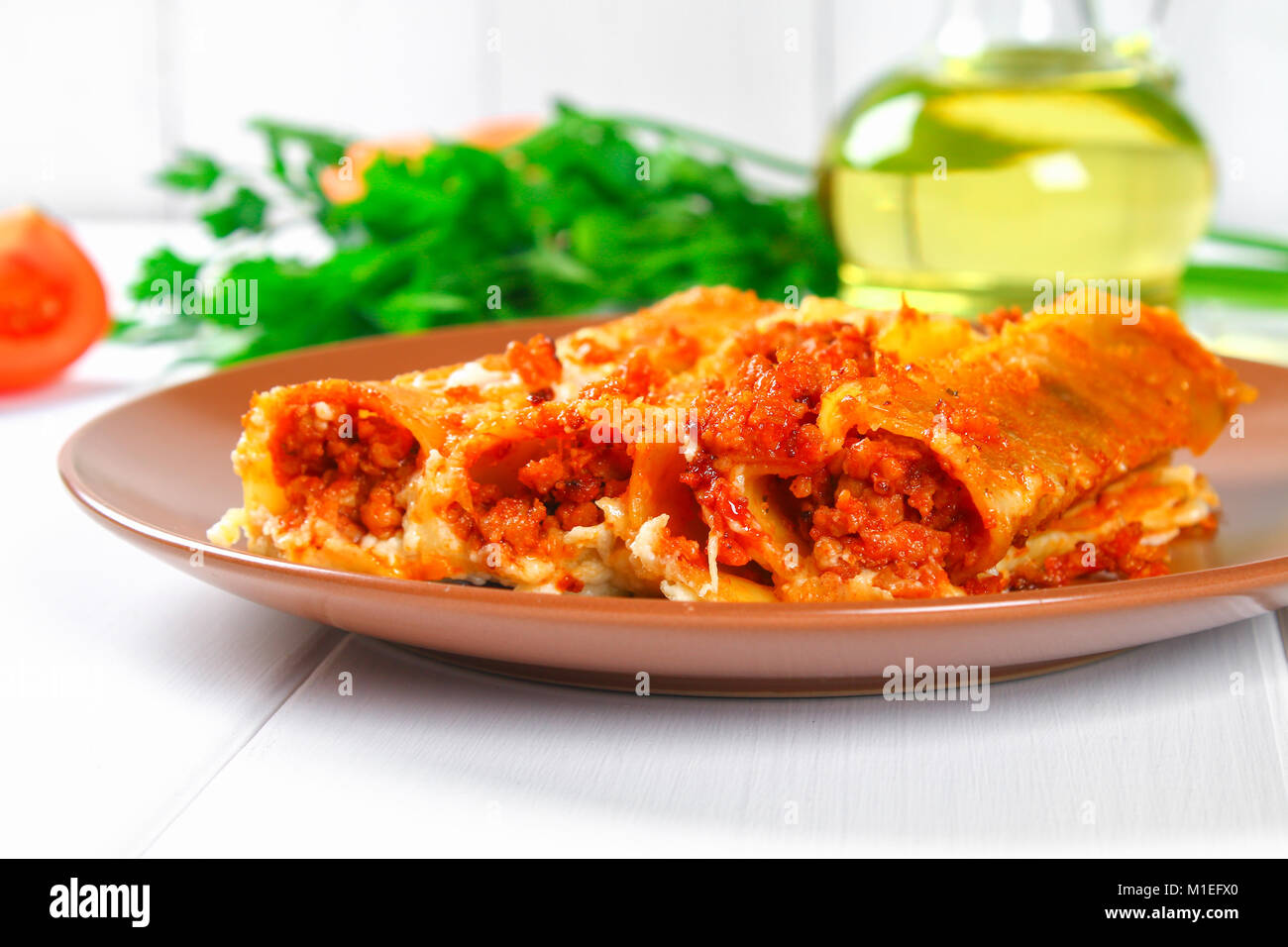 Traditional Italian pasta cannelloni. Baked tubes stuffed with minced ...