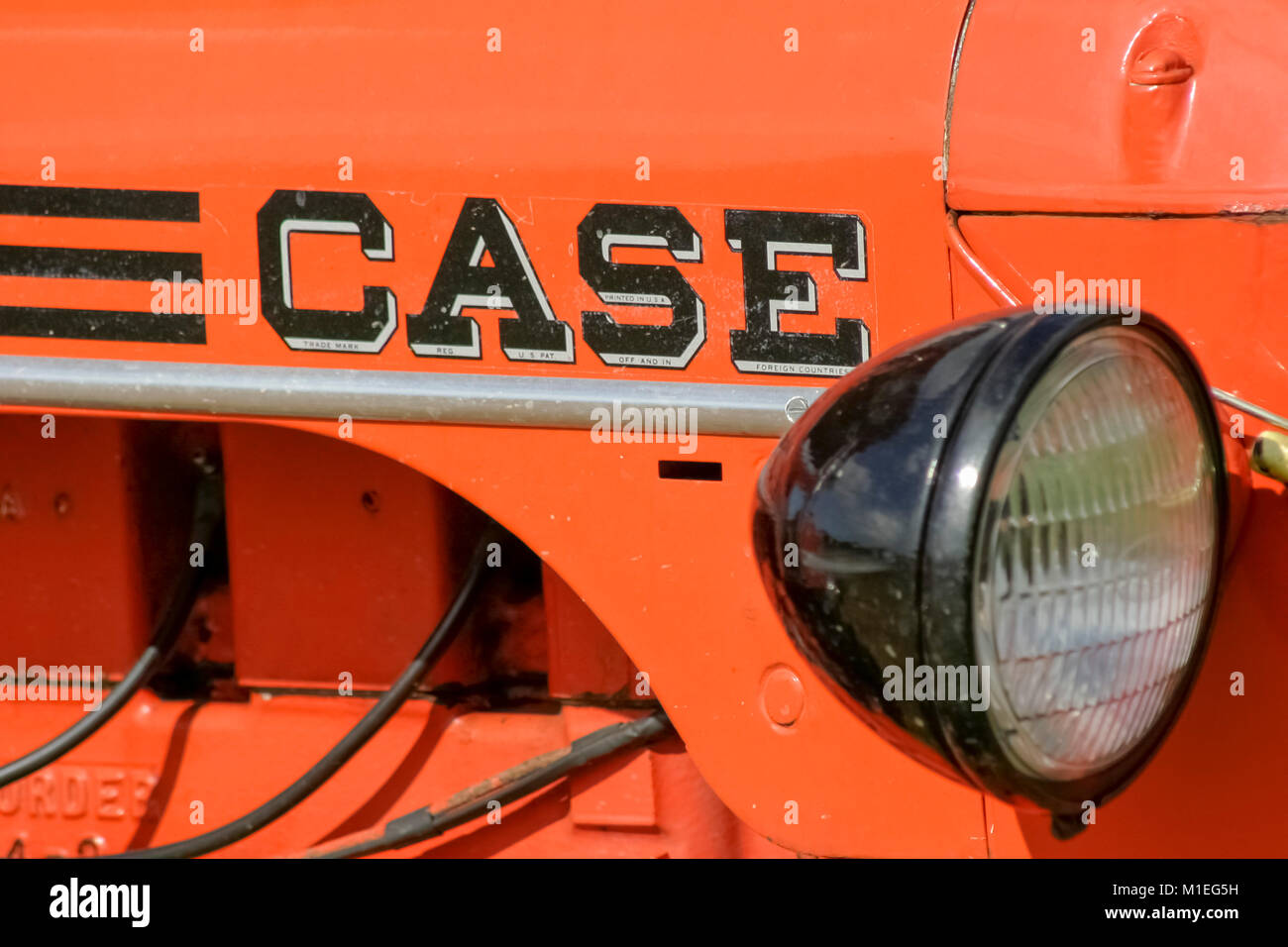 Close up of a restored red Vintage Case Tractor with black headlamp ...