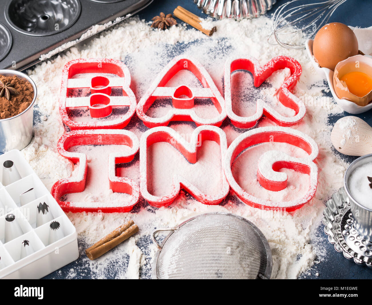 Flour letters spelling Baking with tools and sweet food ingredients ...