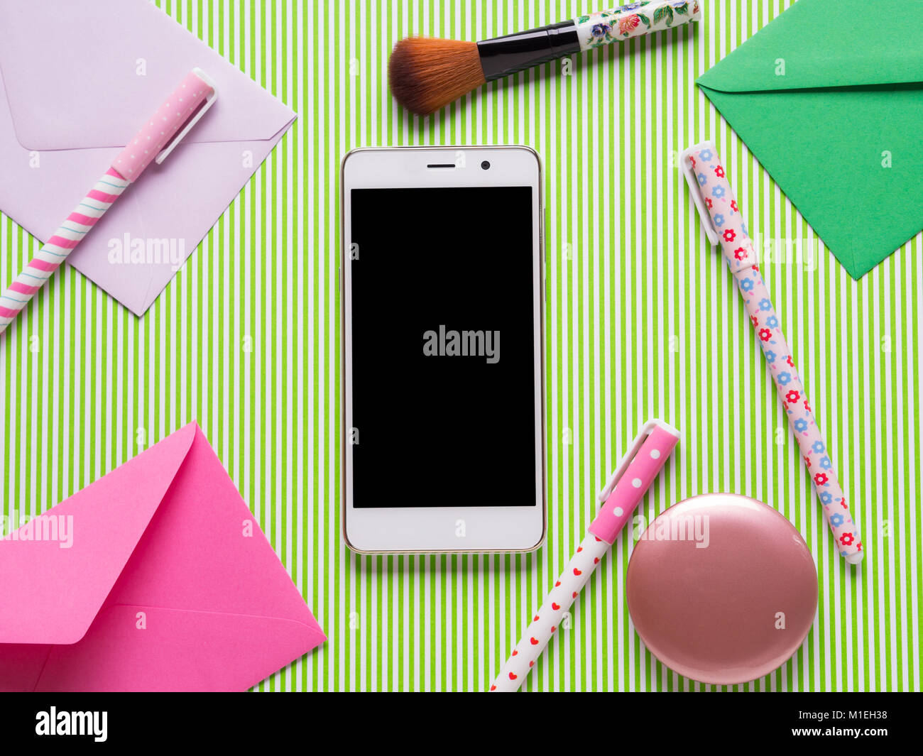 Smartphone black screen and make up girl's accessories flat lay. Girl's ...