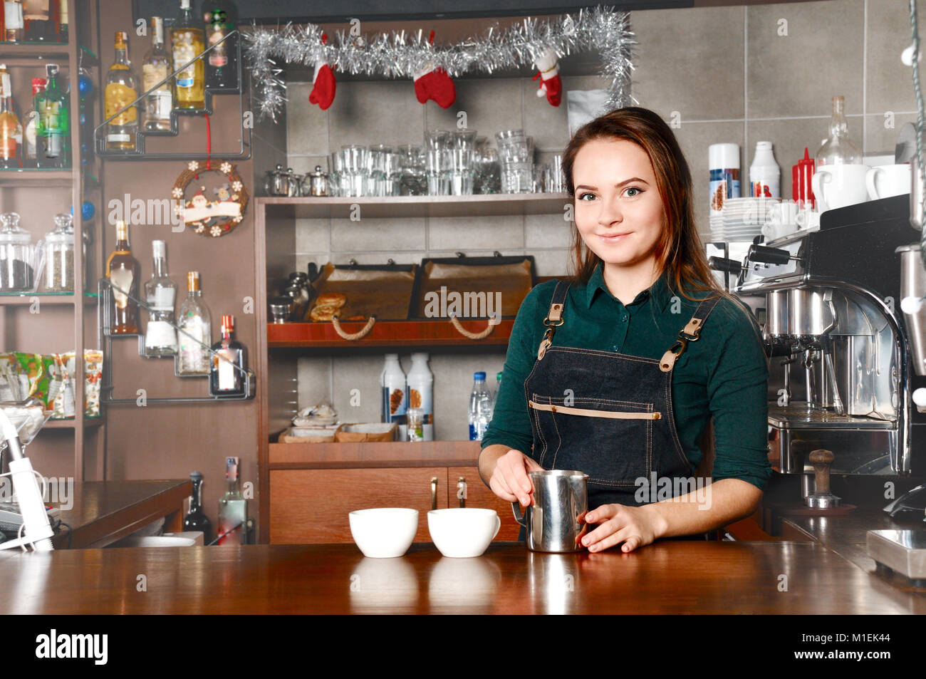 Barista woman at workplace in coffee shop cafe. Food and drink industry ...