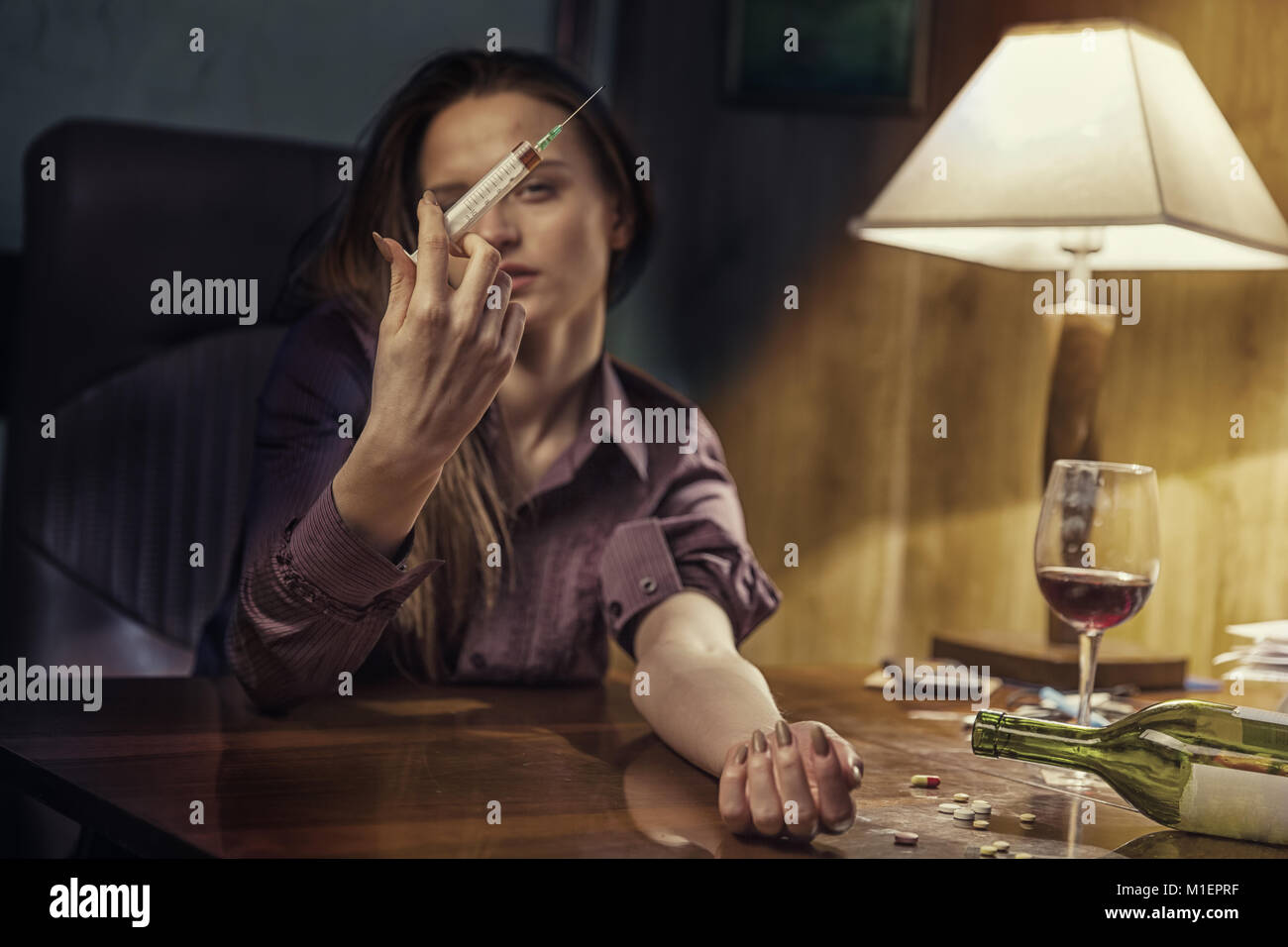 Drug addict young woman with syringe in action in his office Stock ...