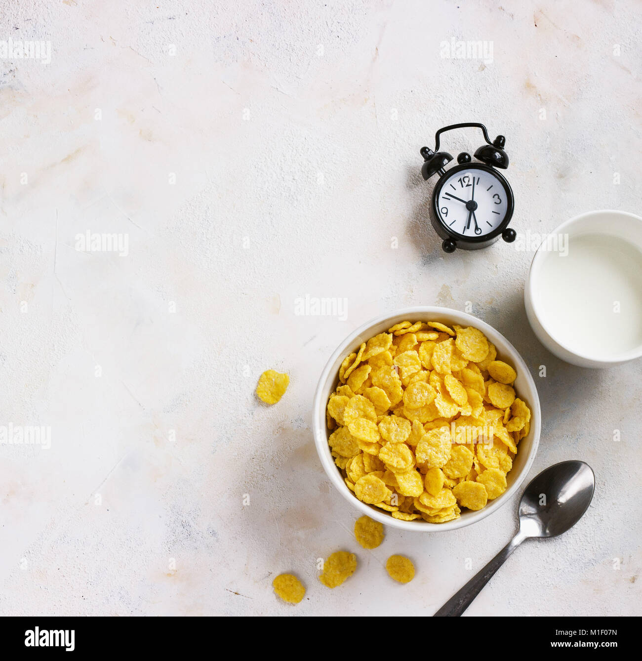Corn flakes, coffee, alarm clock on a light background, breakfast Stock ...
