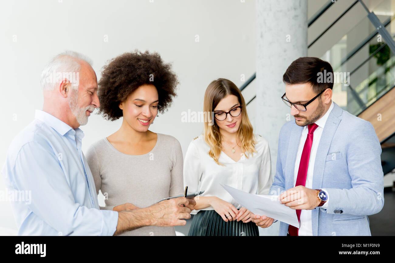 Portrait of multiracial business people standing in the office Stock ...