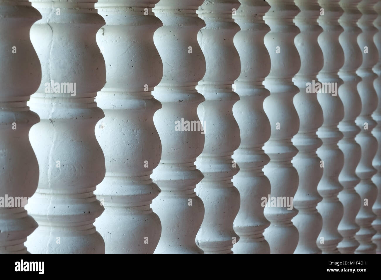 Several white curved columns in one row. Architectural detail of the ...