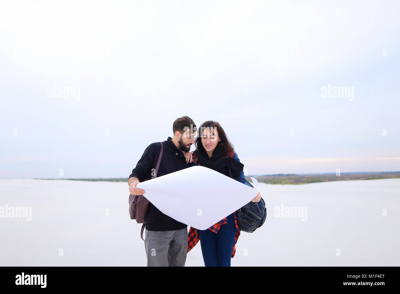 Presenters of travel program married couple viewing map Stock Photo - Alamy