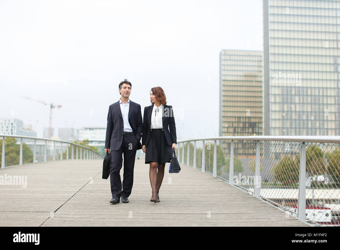 economists male and female in strict suits walking Stock Photo - Alamy
