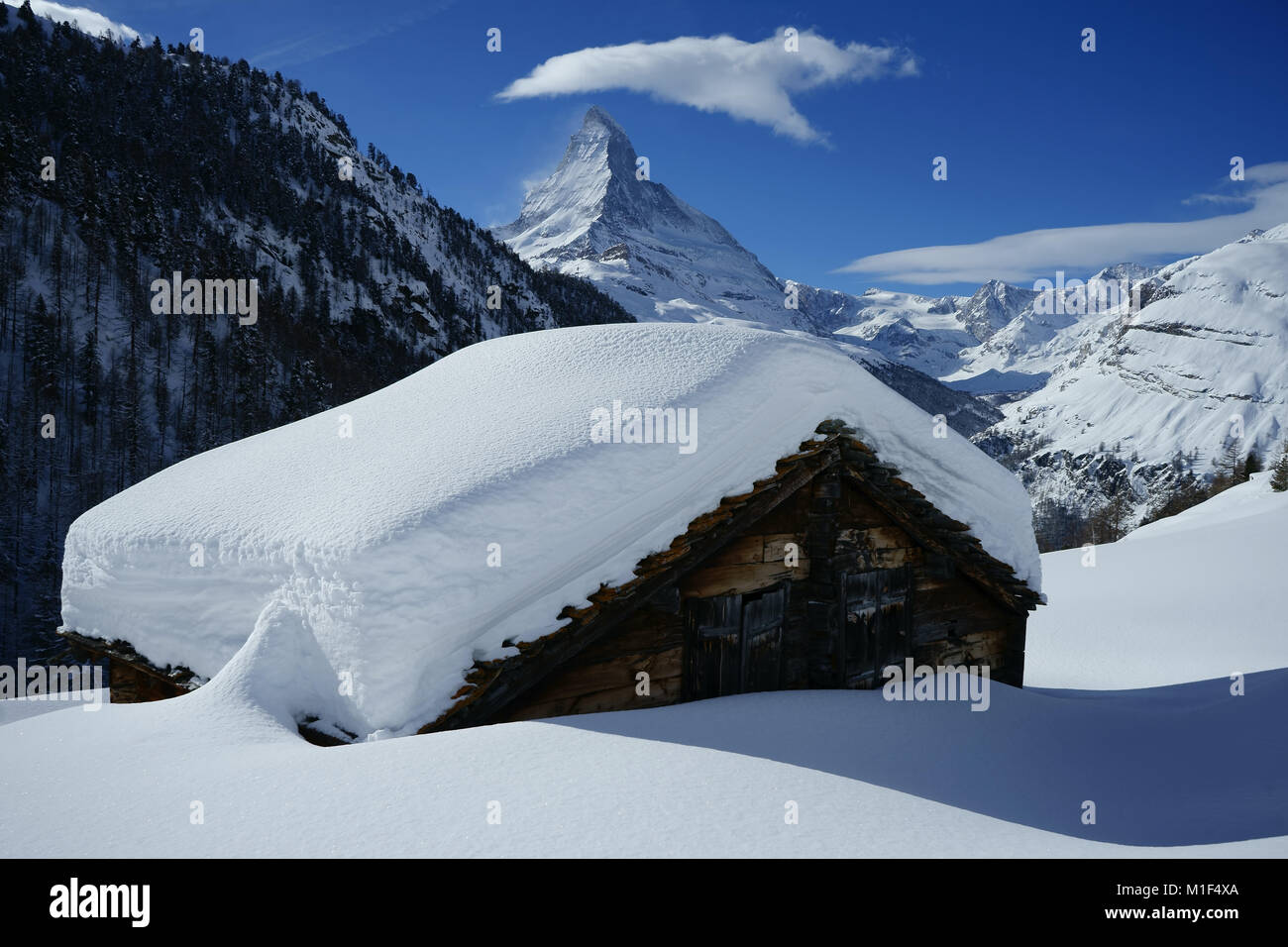 Small alpine barn at Findelnm below Sunnegga and Matterhorn covered in ...
