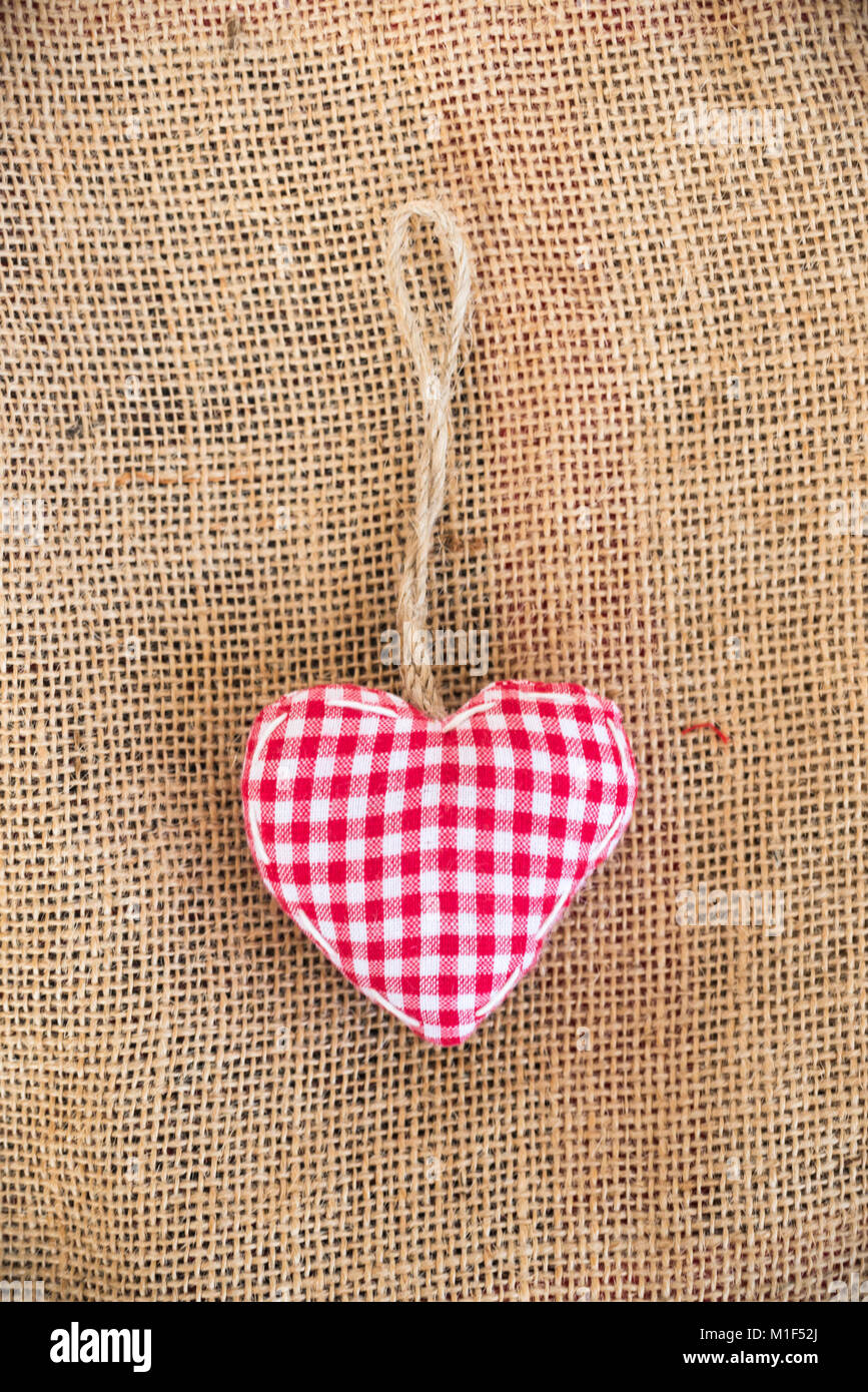 Red fabric heart on rustic canvas background Stock Photo - Alamy