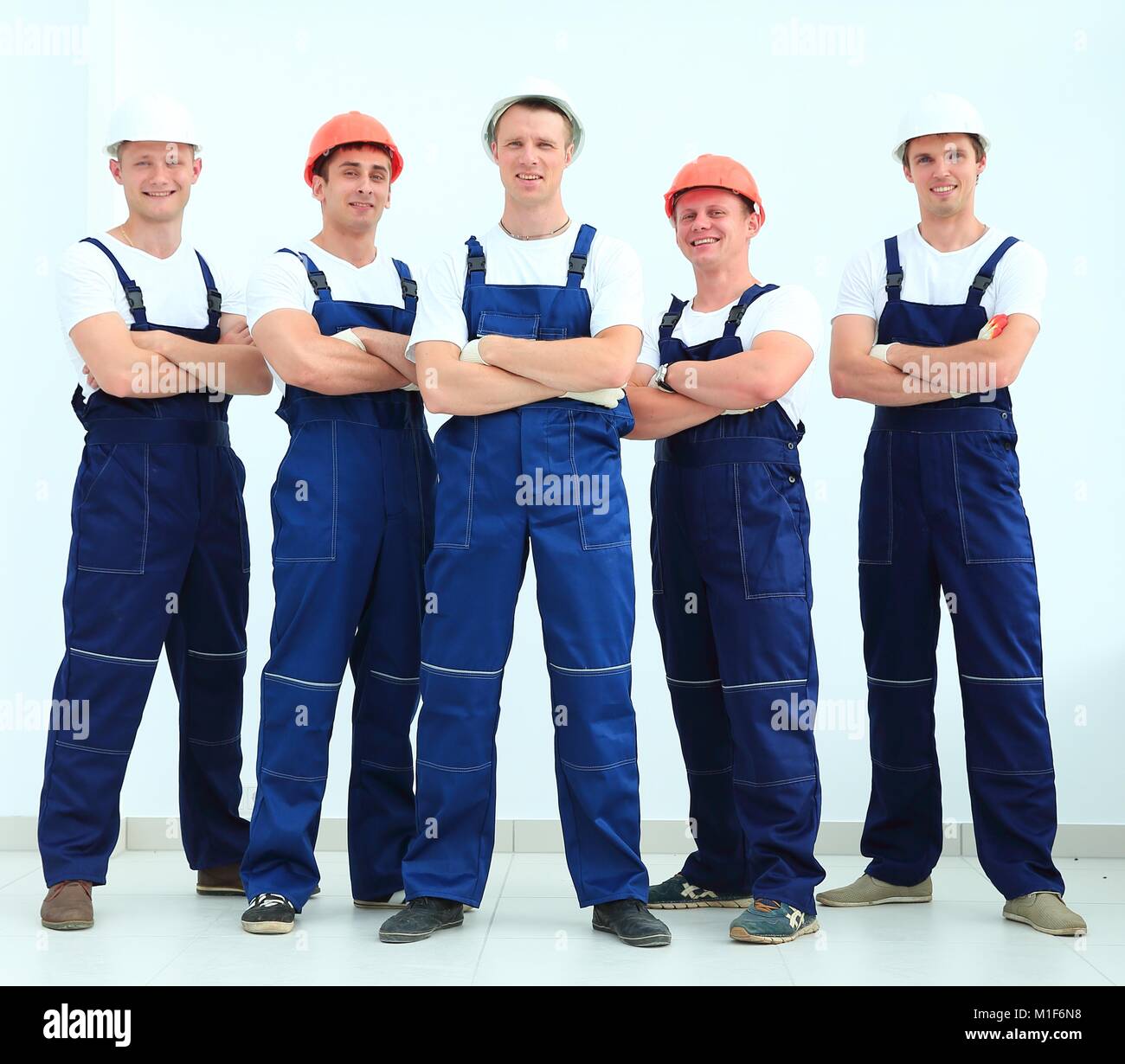 team of professional builders in helmets Stock Photo - Alamy