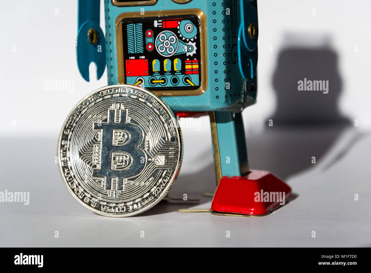 Vintage tin toy robot with bitcoin coin, cryptocurrency mining concept ...