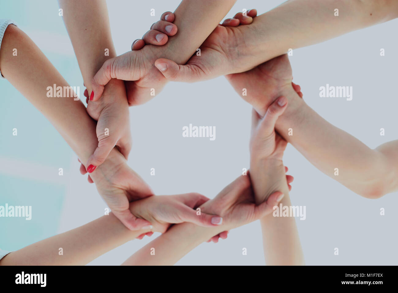 Ring of hands teamwork showing your product Stock Photo - Alamy