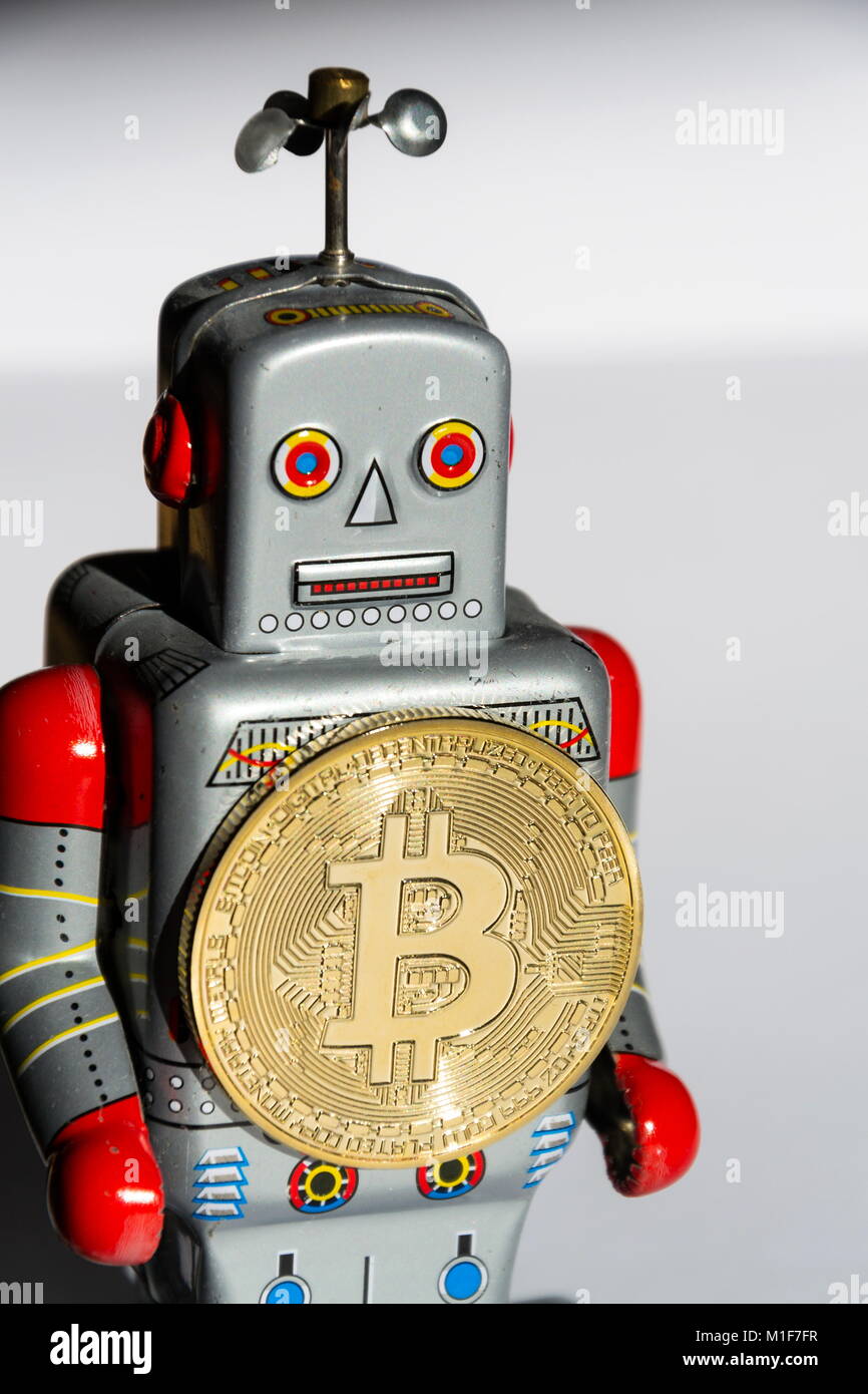 Vintage tin toy robot with bitcoin coin, cryptocurrency mining concept ...