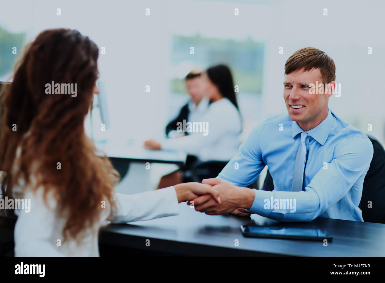 The salesman shaking hands with customers Stock Photo - Alamy