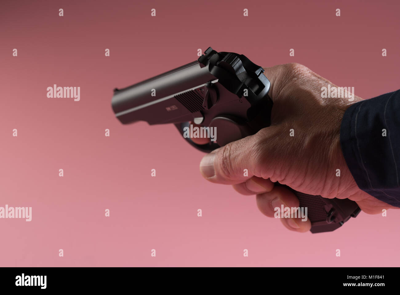 Male hand with gun Stock Photo - Alamy