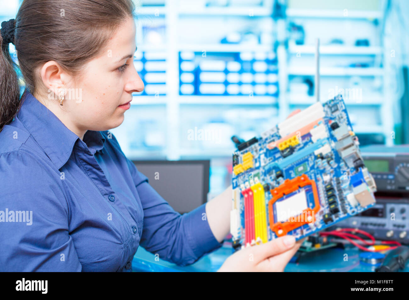 Young woman in electronics repair service center Stock Photo - Alamy
