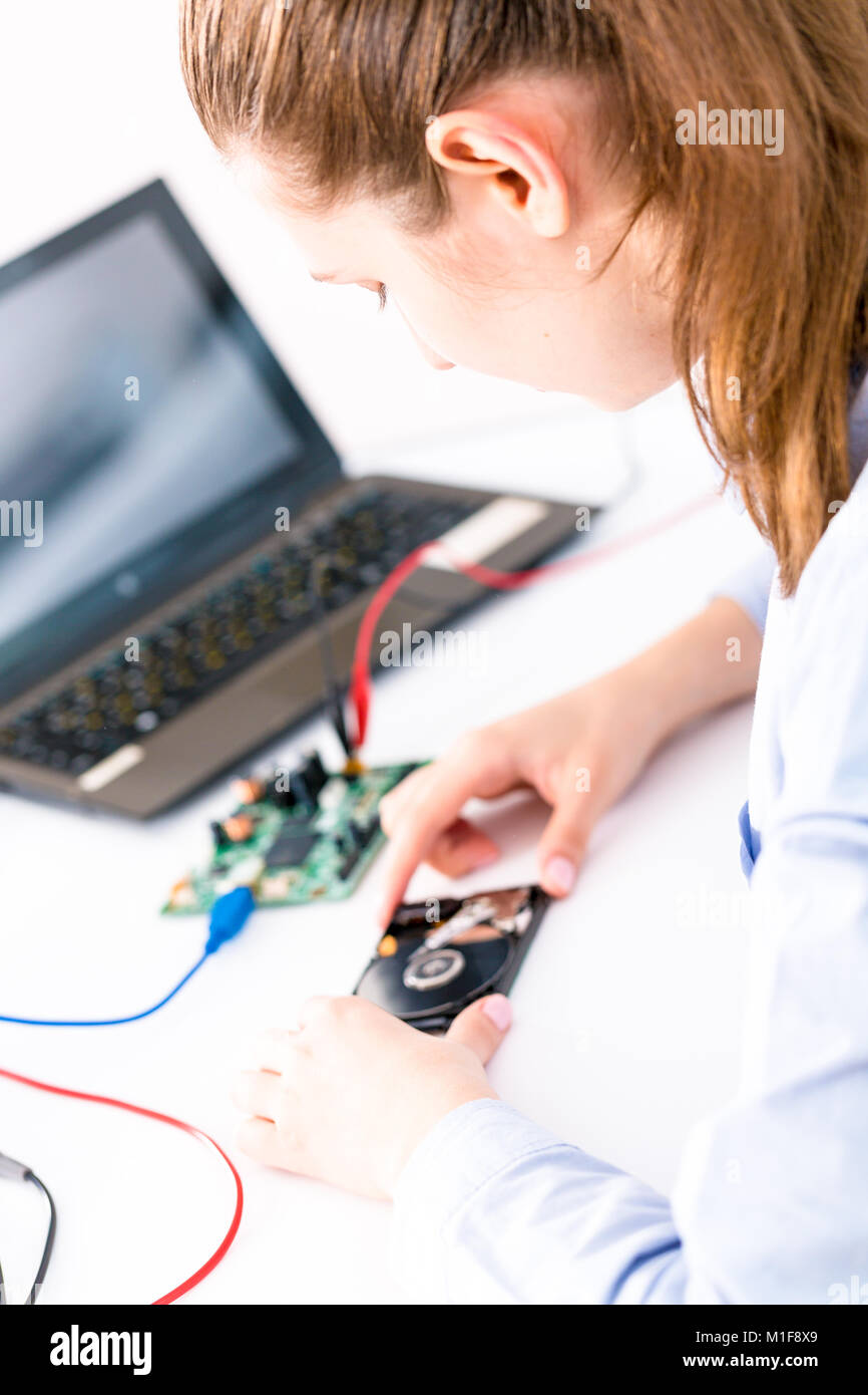 The girl in the lab with the hard drive HDD Stock Photo - Alamy