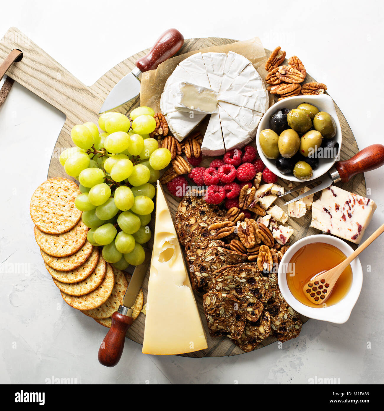 Cheese and snacks plate on white background overhead shot Stock Photo ...
