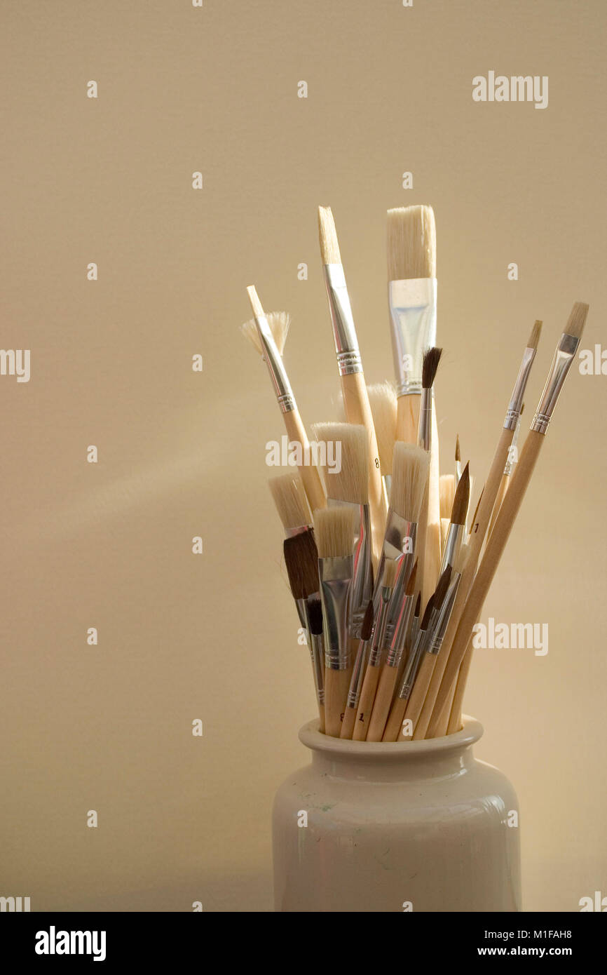 Artists paint brushes in pot Stock Photo - Alamy