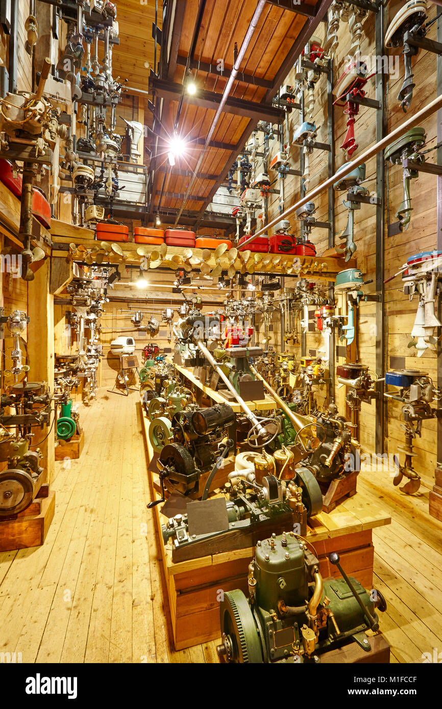 Classic yacht motor collection on a wooden warehouse indoor. Vertical ...
