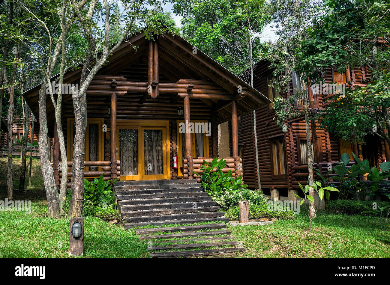 Log house - Cozy log house amongst green environment Stock Photo - Alamy