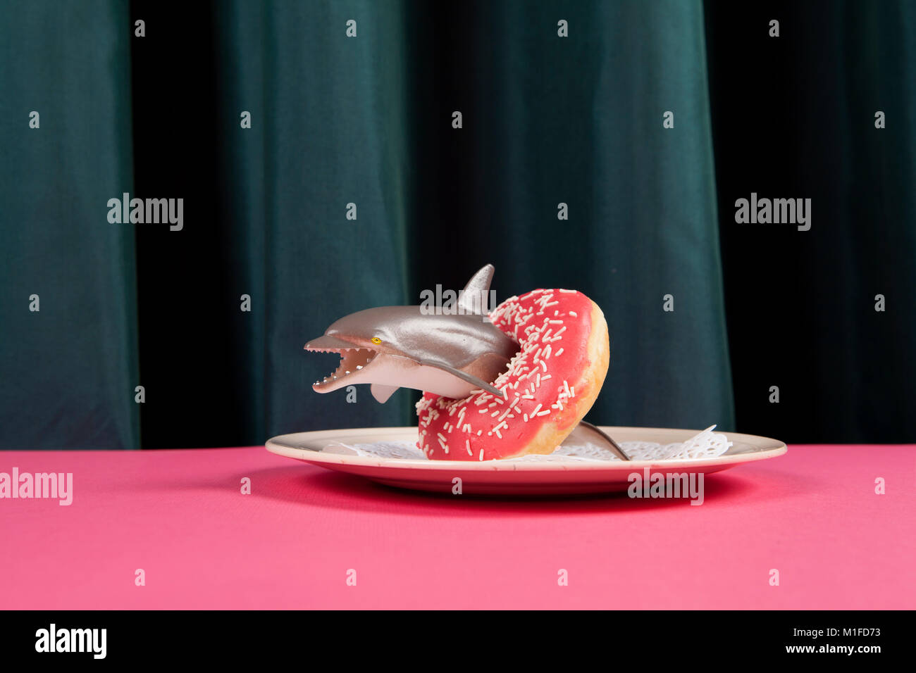 a dolphin plastic toy inside a donut symbolizing a buoy on a vibrant ...